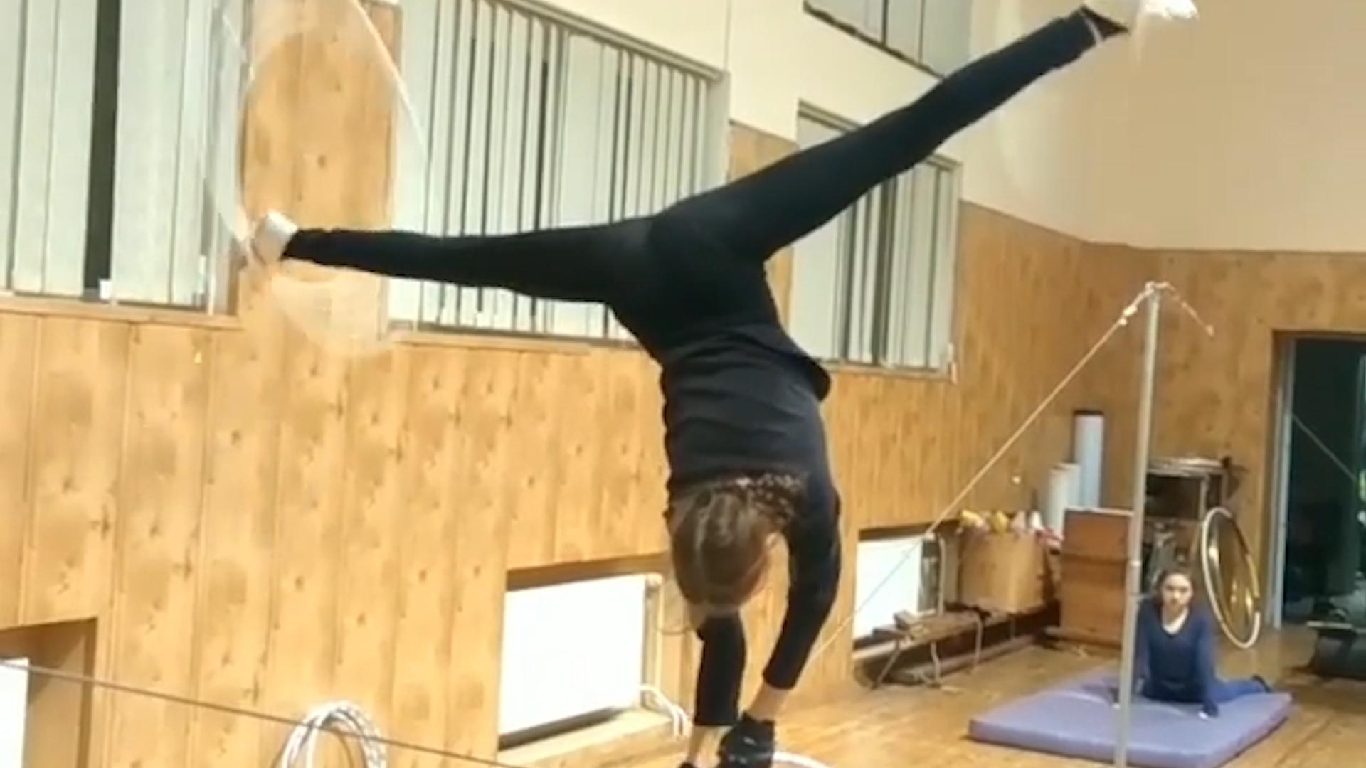 Girl Hula Hoops With Legs While Balancing on Thin Rope - Poke My Heart