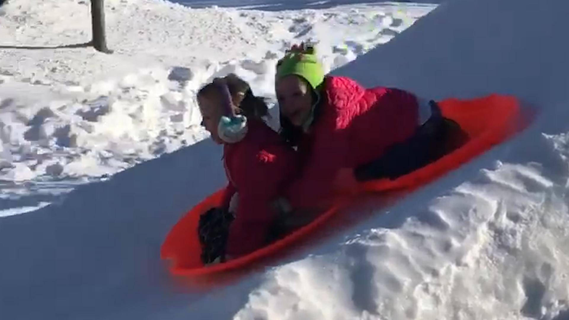 Little Girls Enjoy Sledding Down Homemade Snow Slide - Poke My Heart