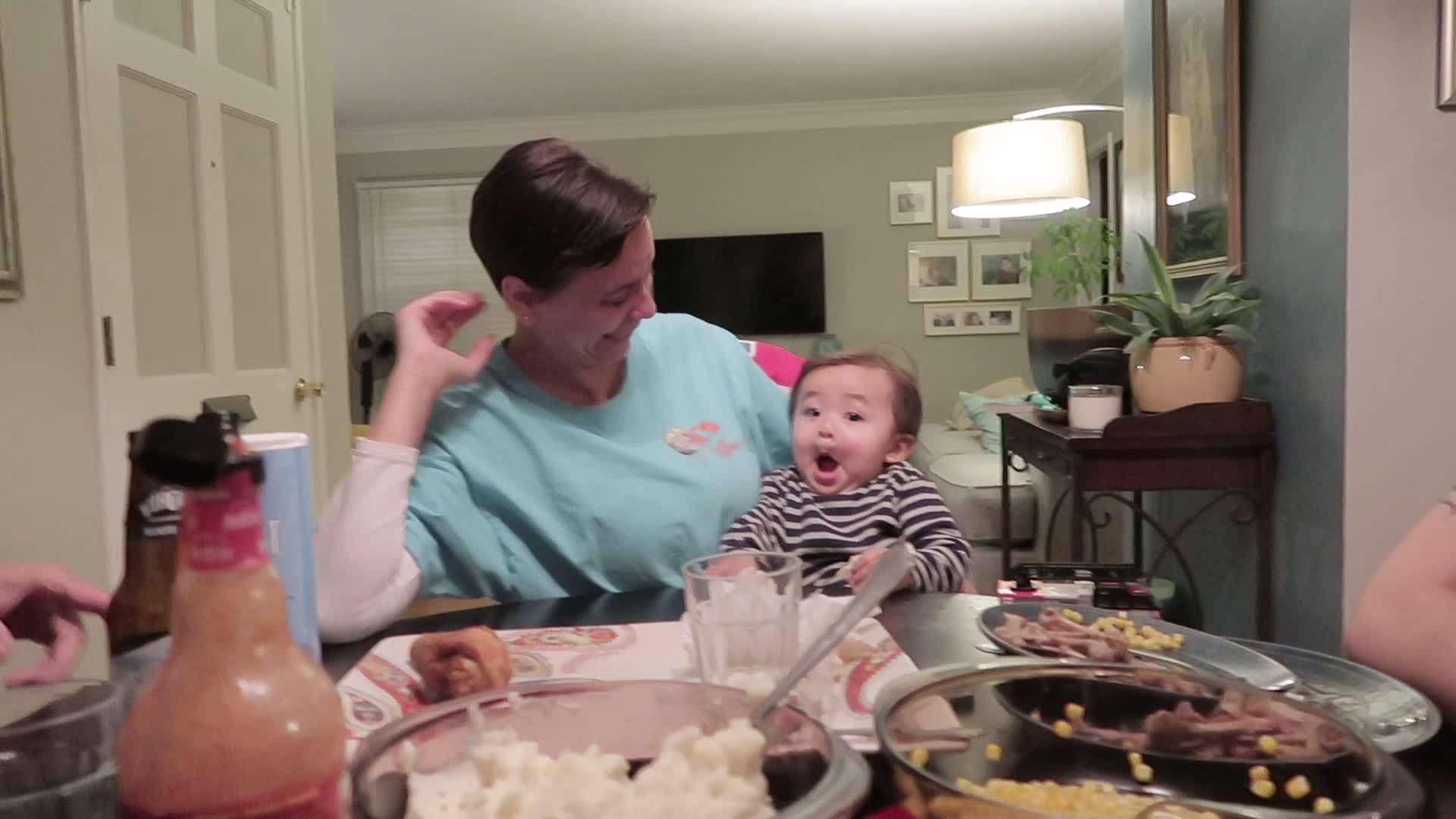 Baby Makes Funny Faces While Sitting at Dinner Table Making Everyone ...